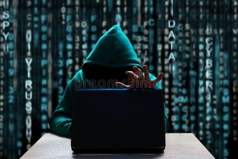 Unknown Hacker in the Hood with a Laptop in His Hand on a Background of ...