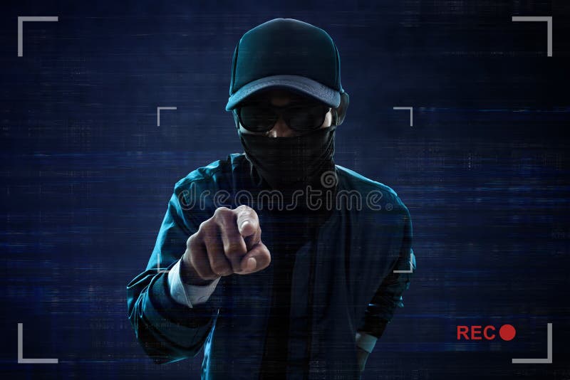 Unknown Hacker in the Hood with a Laptop in His Hand on a Background of ...