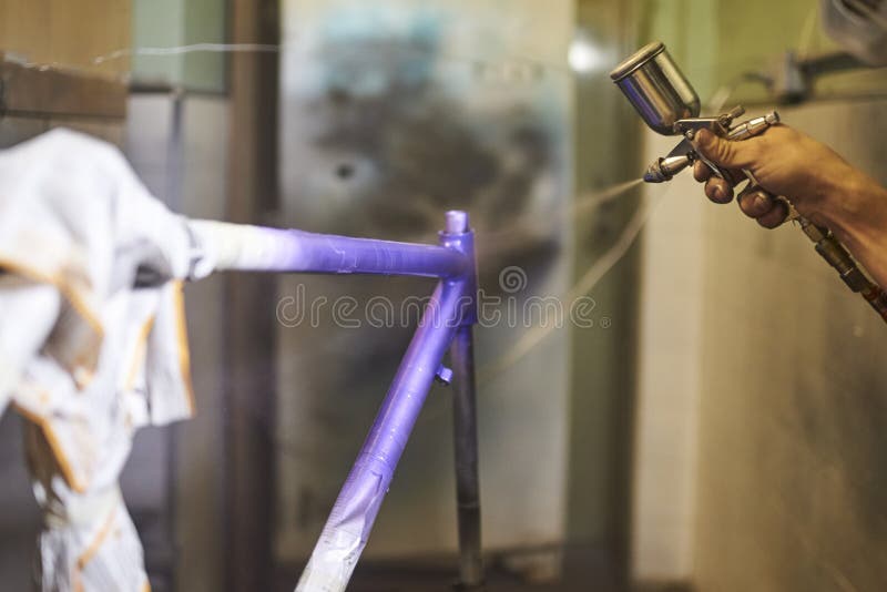 Unknown Man Spray Painting a Bicycle Frame in His Workshop Stock Image ...