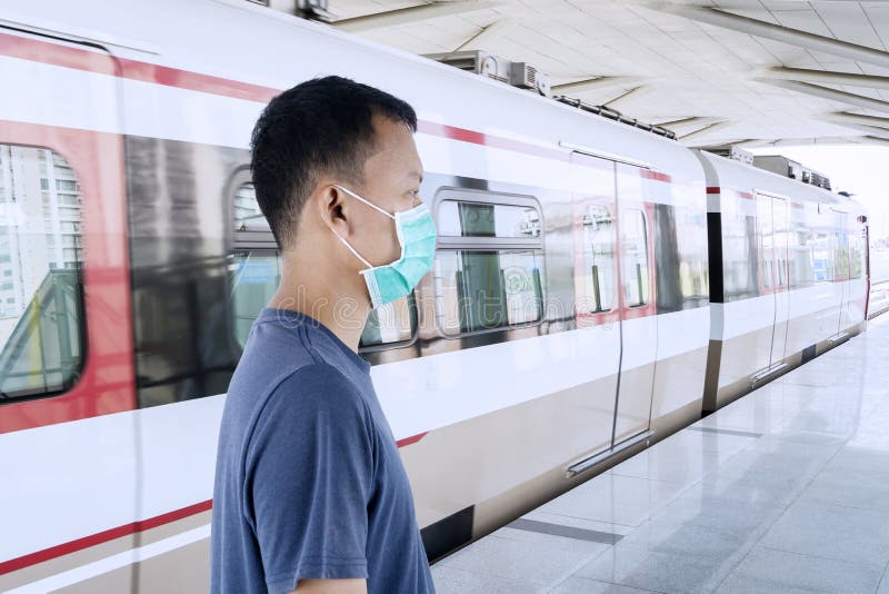 Unknown Man Standing in Train Station with Mask Stock Image - Image of ...