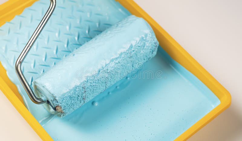 Unknown Person Dips Roller into Blue Paint, Rolling Out on Plastic Tray ...