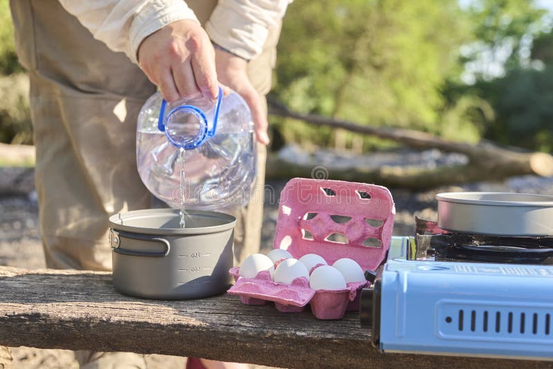 Unknown Person Pouring Water into a Pot, Cooking Breakfast while ...
