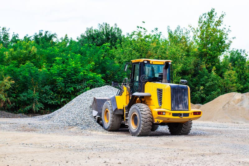 Bulldozer Working Digs Sand and Gravel in Quarry. Heavy Construction ...