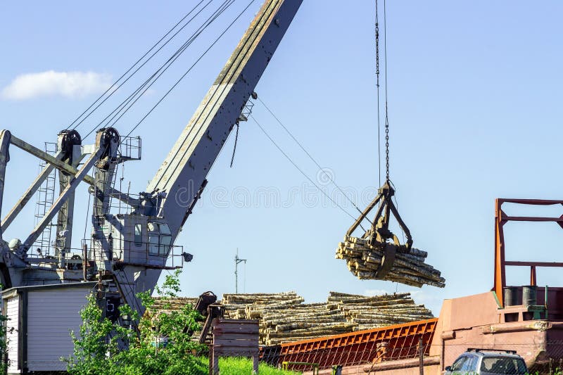 Unloading a Barge with Logs Using a Crane Stock Image - Image of ...