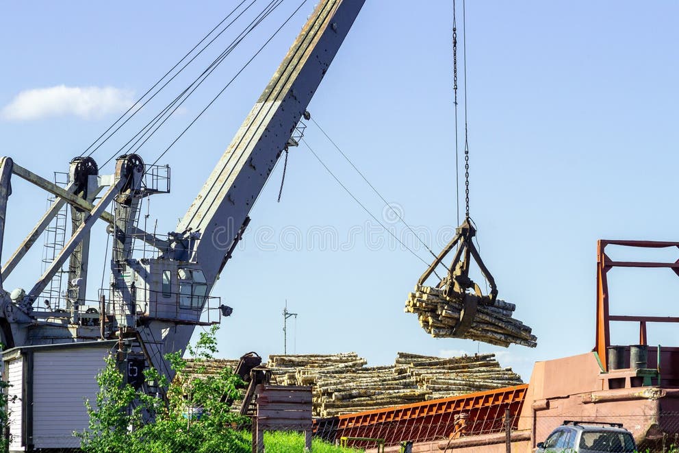 Unloading a Barge with Logs Using a Crane Stock Image - Image of ...
