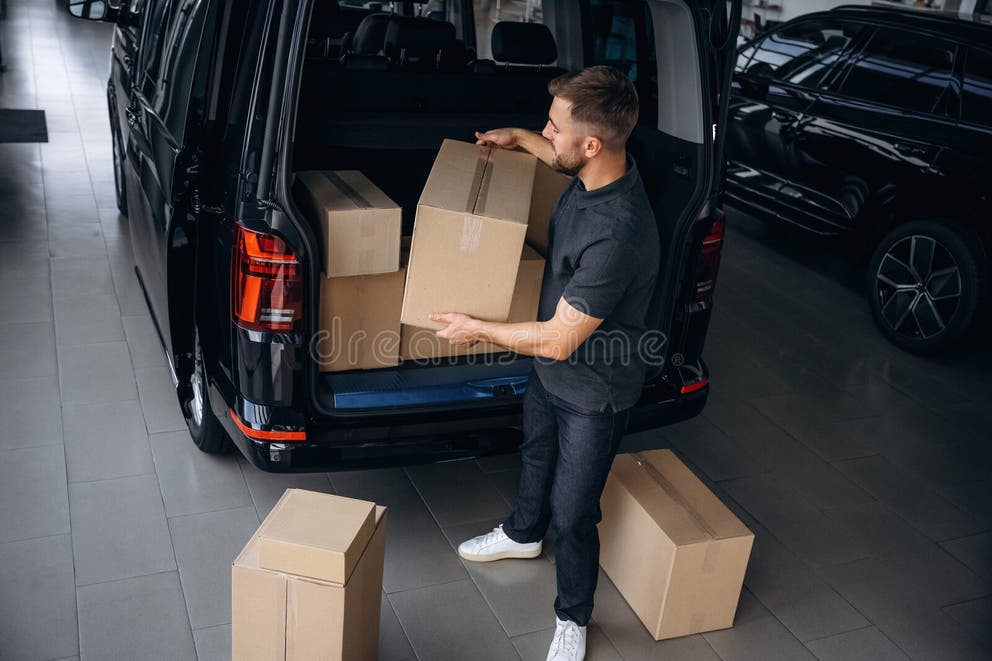Unloading the Boxes. Delivery Man or Loader is Near the Car Stock Photo ...