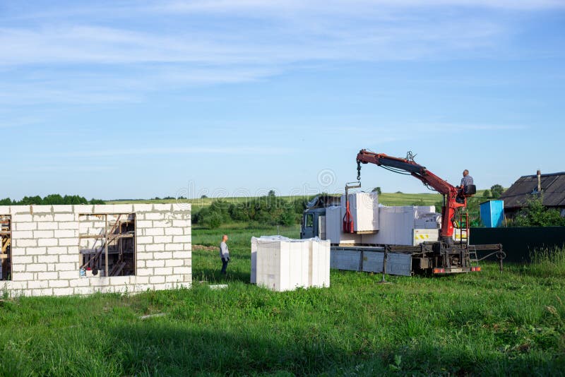 Unloading Building Blocks from a Truck Using a Crane. Hydraulic ...