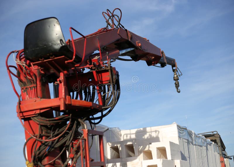 Unloading Building Blocks from a Truck Using a Crane. Hydraulic ...