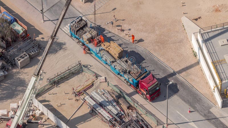 Unloading of Building Materials by Crane at the Construction Site ...