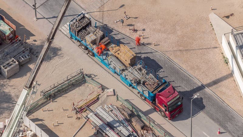 Unloading of Building Materials by Crane at the Construction Site ...
