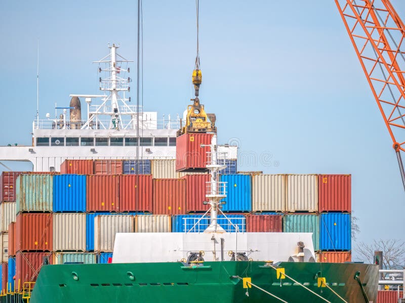 Unloading Cargo Ship in Industrial International Port. Port Crane ...