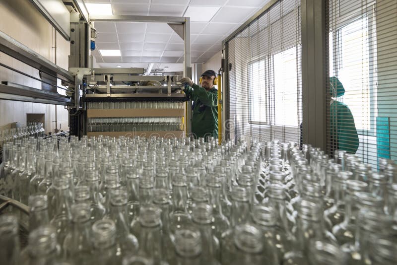 Unloading Glass Bottles with an Automatic Machine. Stock Photo - Image ...