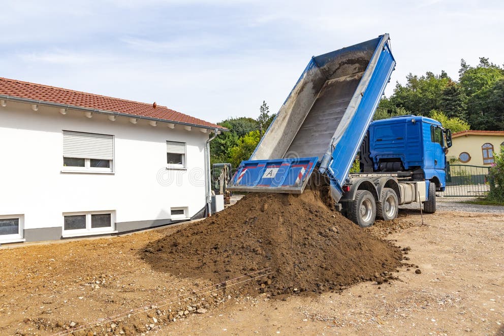 Unloading the Truck with Potting Soil from the Truck Bed at the ...