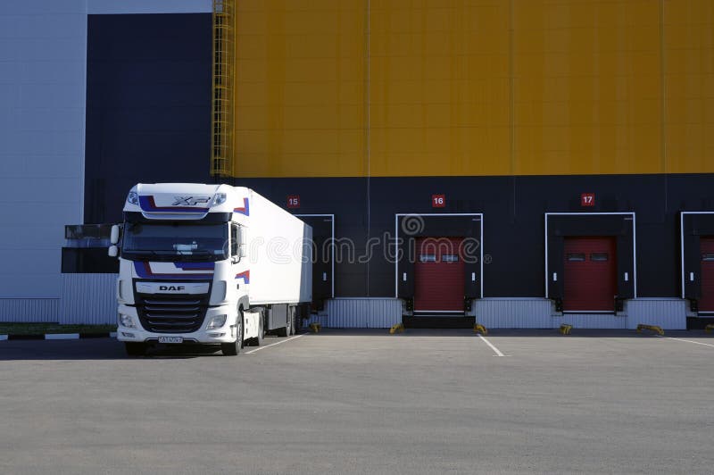 Unloading Trucks in a Modern Warehouse Complex. Transportation, Storage ...
