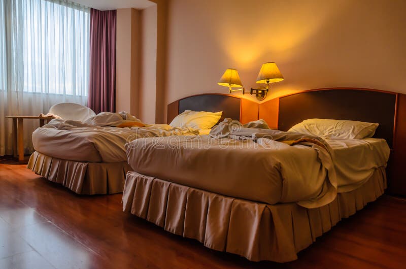 An Unmade Bed of a Hotel Room Stock Image - Image of quilt, lamp: 43922319