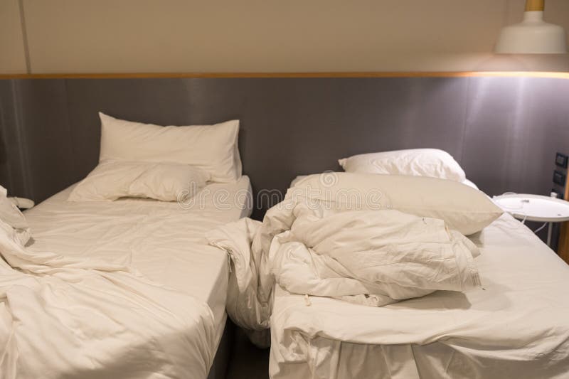 Unmade Double Empty Bed with White Linens. Sheets and Pillows in the ...