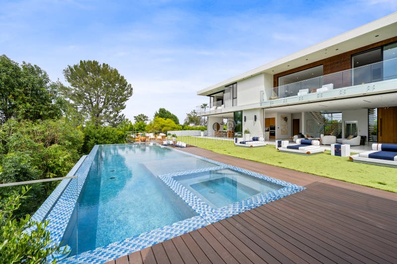 Unoccupied Pool Surrounded by Trees and a Deck Underneath Stock Image ...