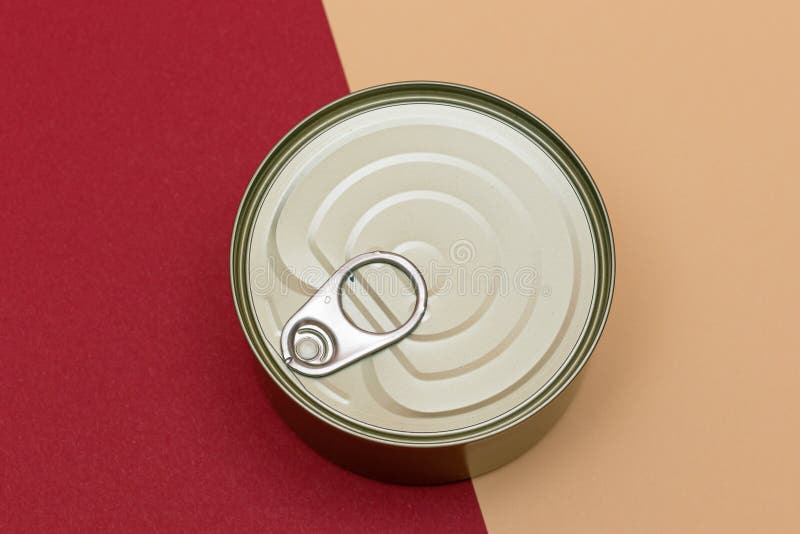 Unopened Tin Can with Blank Edge on Split Red and Beige Background ...