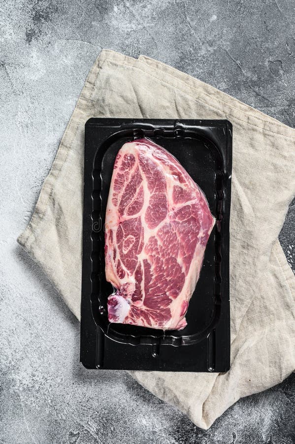 Unopened Vacuum Pack of Pork Steak Isolated on Black Background ...