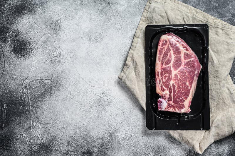 Unopened Vacuum Pack of Pork Steak Isolated on Black Background ...
