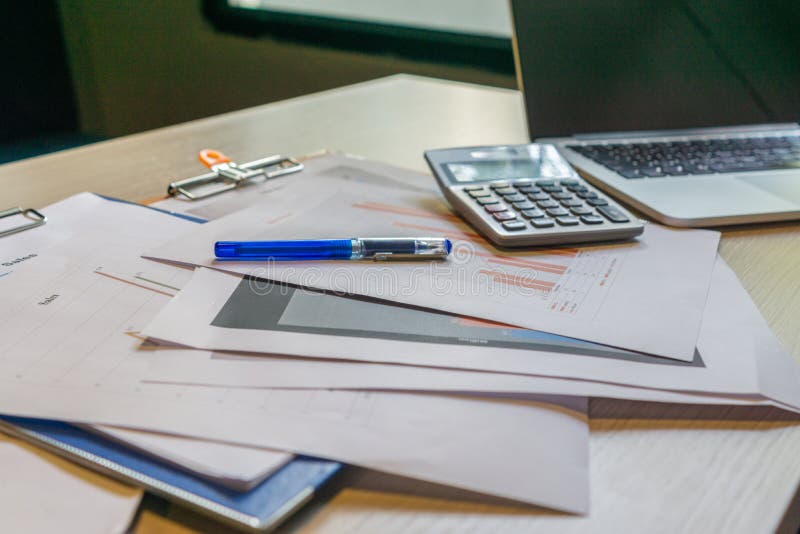 Unorganized Office Desk with Laptop Calculator and Paperwork Stock ...