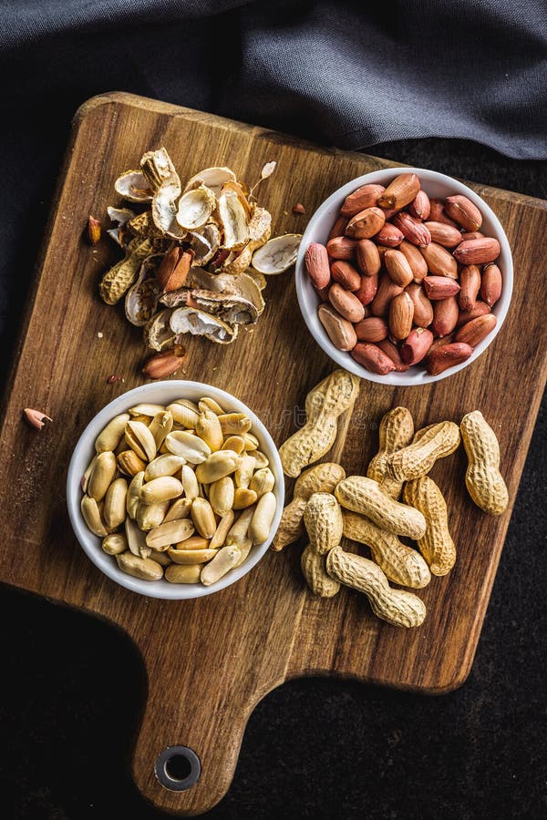 Unpeeled and Peeled Peanuts in Bowl on Kitchen Table. Top View Stock ...