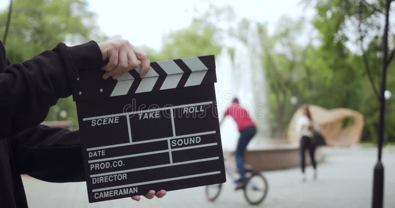 Clapperboard in Male Caucasian Hands Clipping Leaving and Young Woman ...