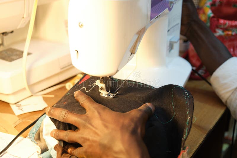 Unrecognizable African Tailor Sewing a Hat with Sewing Machine at ...