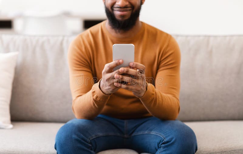 Unrecognizable Black Guy Using Phone Indoors, Cropped, Focus on ...