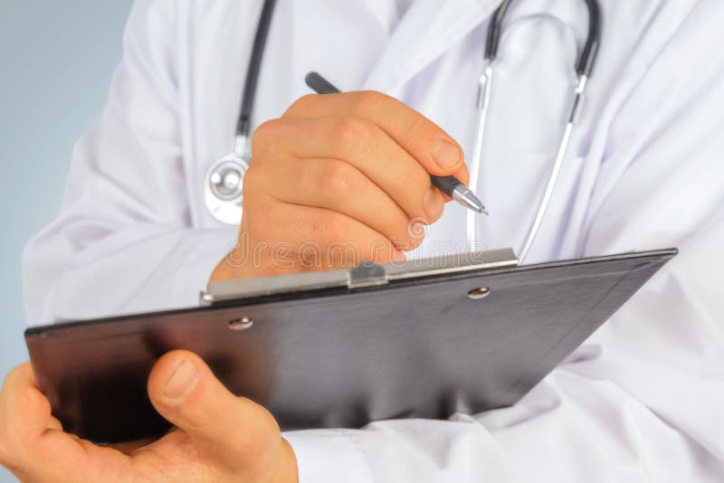 Doctor Writing on Medical Chart Stock Photo - Image of care, form: 31048324