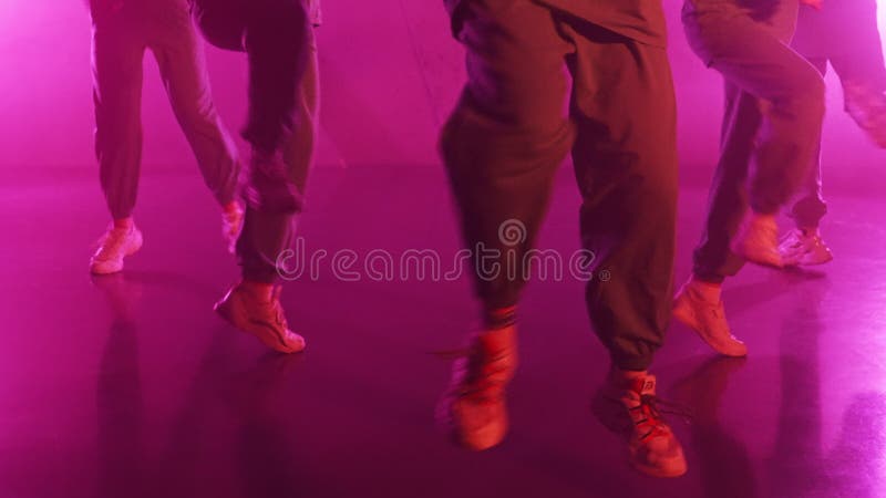 Unrecognizable Group of People are Dancing a Modern Dance in Pink Neon ...