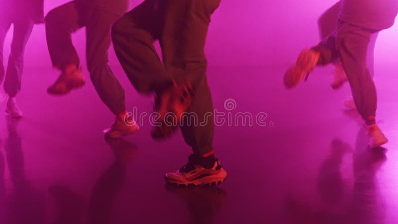 Unrecognizable Group of People are Dancing a Modern Dance in Pink Neon ...