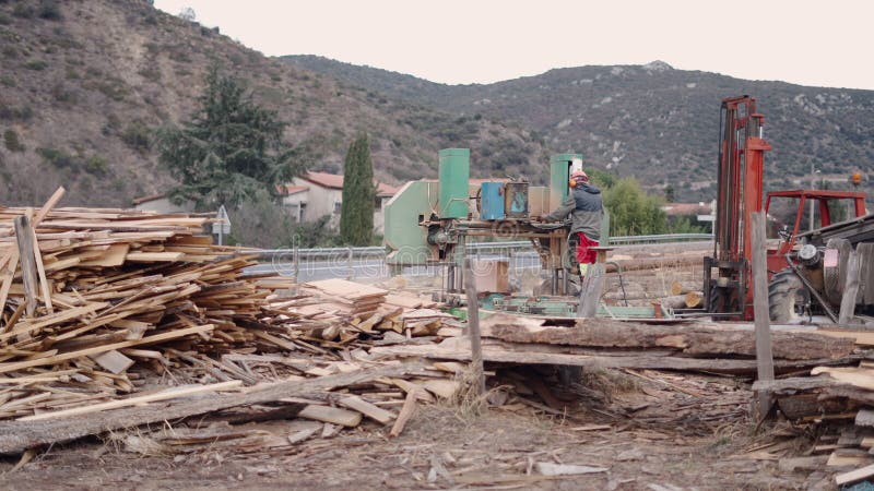 An Unrecognizable Guy Operating a Wood Cutting Machine Stock Footage ...