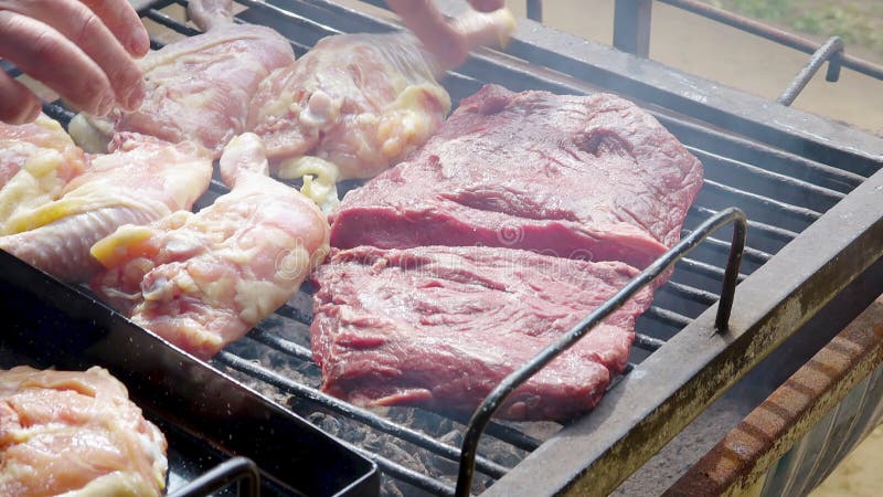 Unrecognizable Hand Flipping Beef and Chicken on the Grill during a ...
