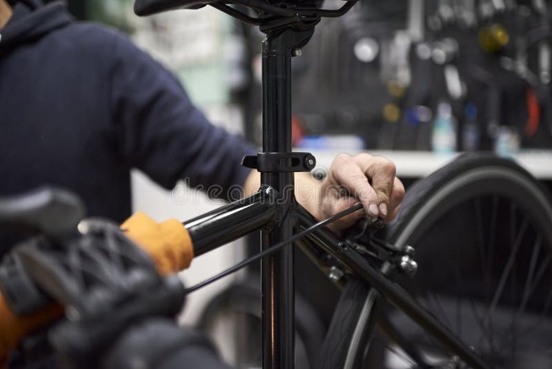 Man Assembling the Braking and Shifting System of a Bicycle at His ...