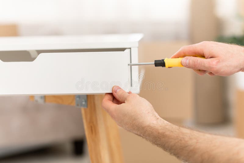Unrecognizable Man Assembling Wooden Table Using Screwdriver Indoors ...