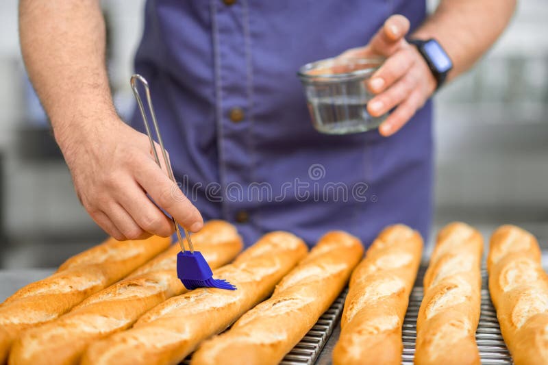 Unrecognizable Man Baker in Uniform Baking Baguettes Stock Image ...