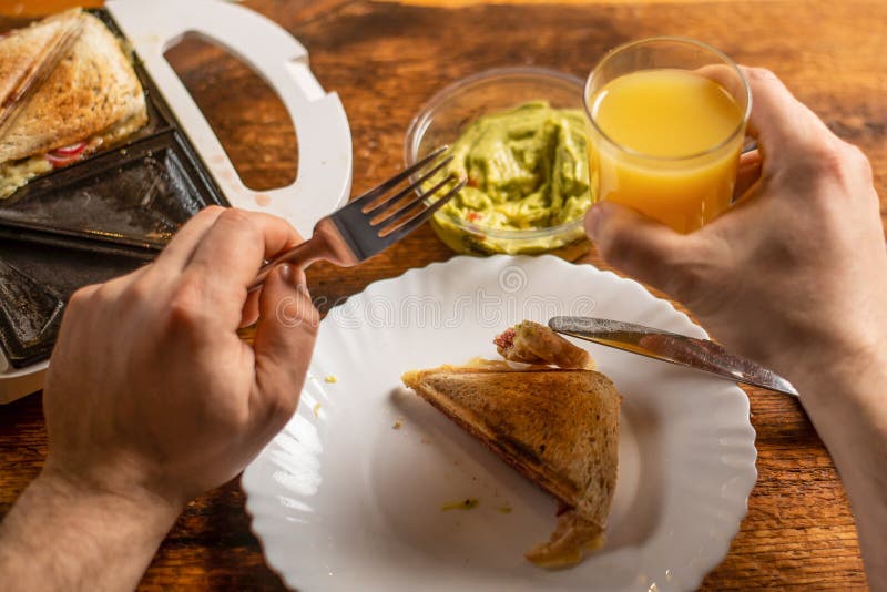 Unrecognizable Man Eats Toast on a Plate. Breakfast Time Stock Photo ...