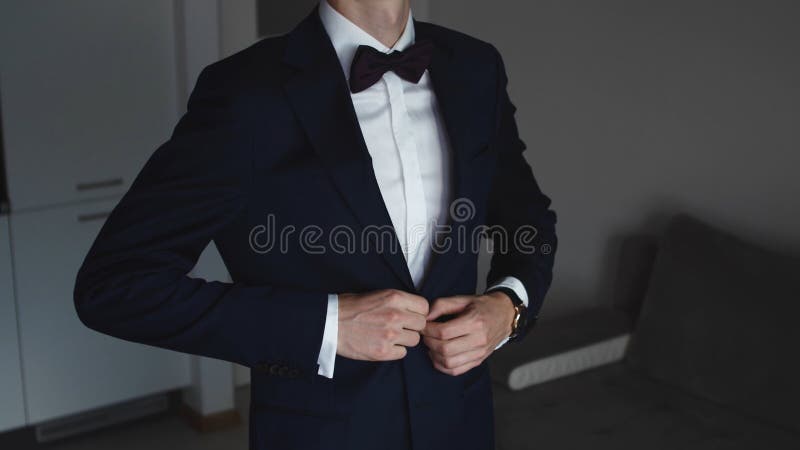 Unrecognizable Man in Elegant Suit with Neck Bow Closing the Button ...