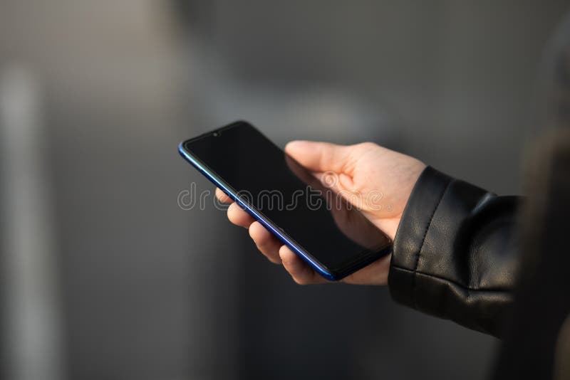 Unrecognizable Man Holding Mobile Phone in Hand, Blurred Background ...