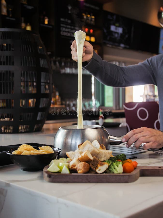 Unrecognizable Man Melting Cheese in a Restaurant Stock Photo - Image ...