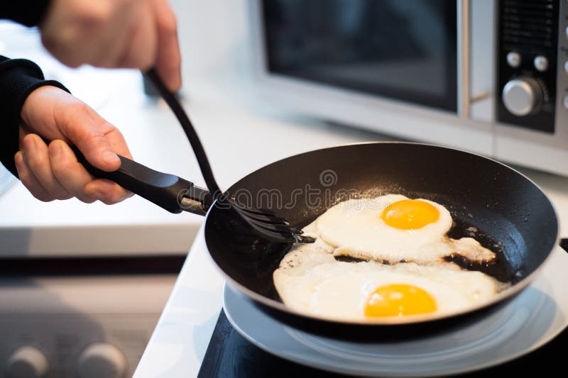 Unrecognizable Man Preparing Fried Eggs for Breakfast. Close Up. Stock ...