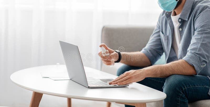 Unrecognizable Man Sanitizing Laptop Keyboard Surface with Disinfectant ...