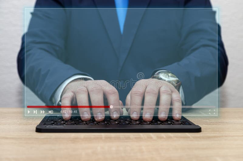 Unrecognizable Man in a Suit is Typing on a Keyboard with a Video ...