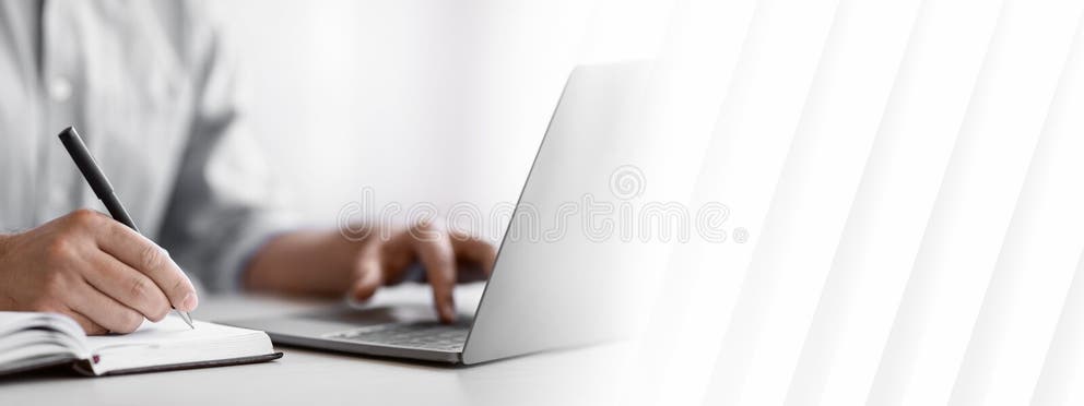 Unrecognizable Man Writing in Notepad and Using Laptop in Office ...