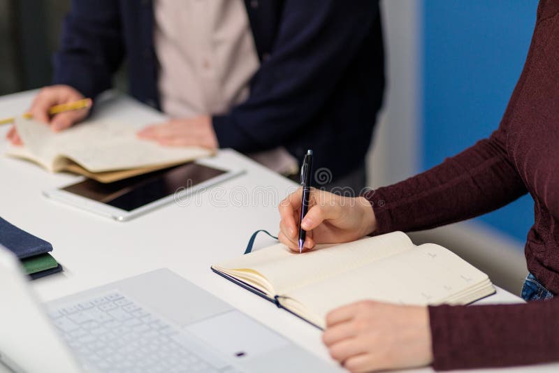 Unrecognizable People Sitting at a Table and Taking Notes Stock Image ...