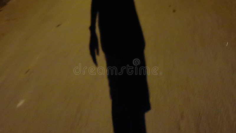 Unrecognizable Person`s Shadow Walking on the Street at Night. Stock ...
