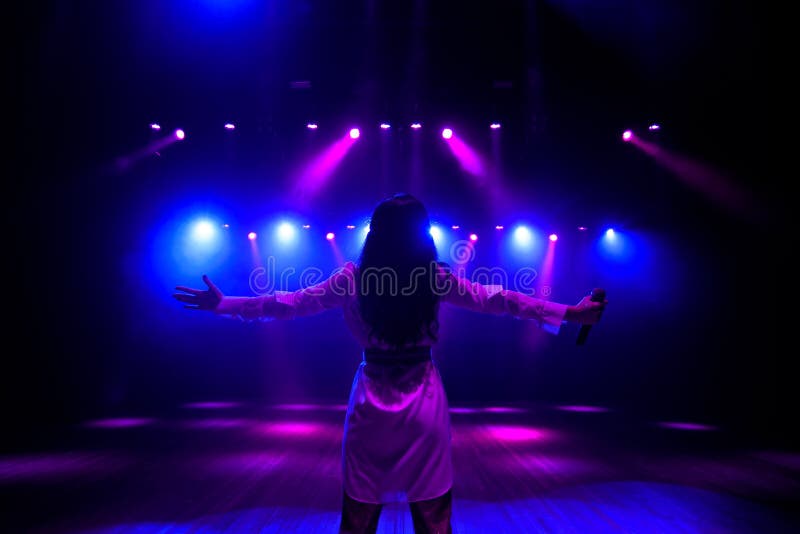 Unrecognizable Singer Standing on Stage at Microphone, Back View, Neon ...