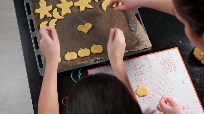 Unrecognizable Woman and Boy Spread Out Dough of Different Shapes on a ...