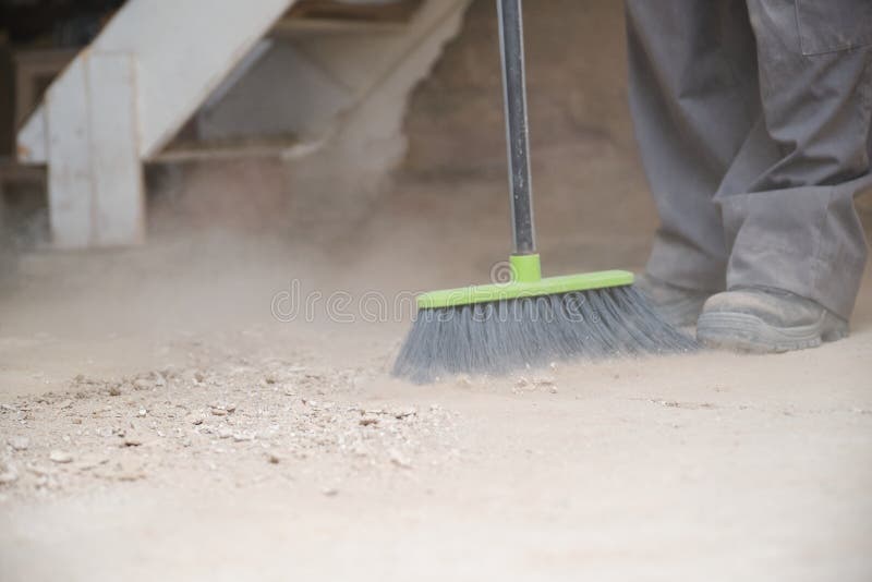 Unrecognizable Young Builder Sweeping the Floor at a Construction Site ...